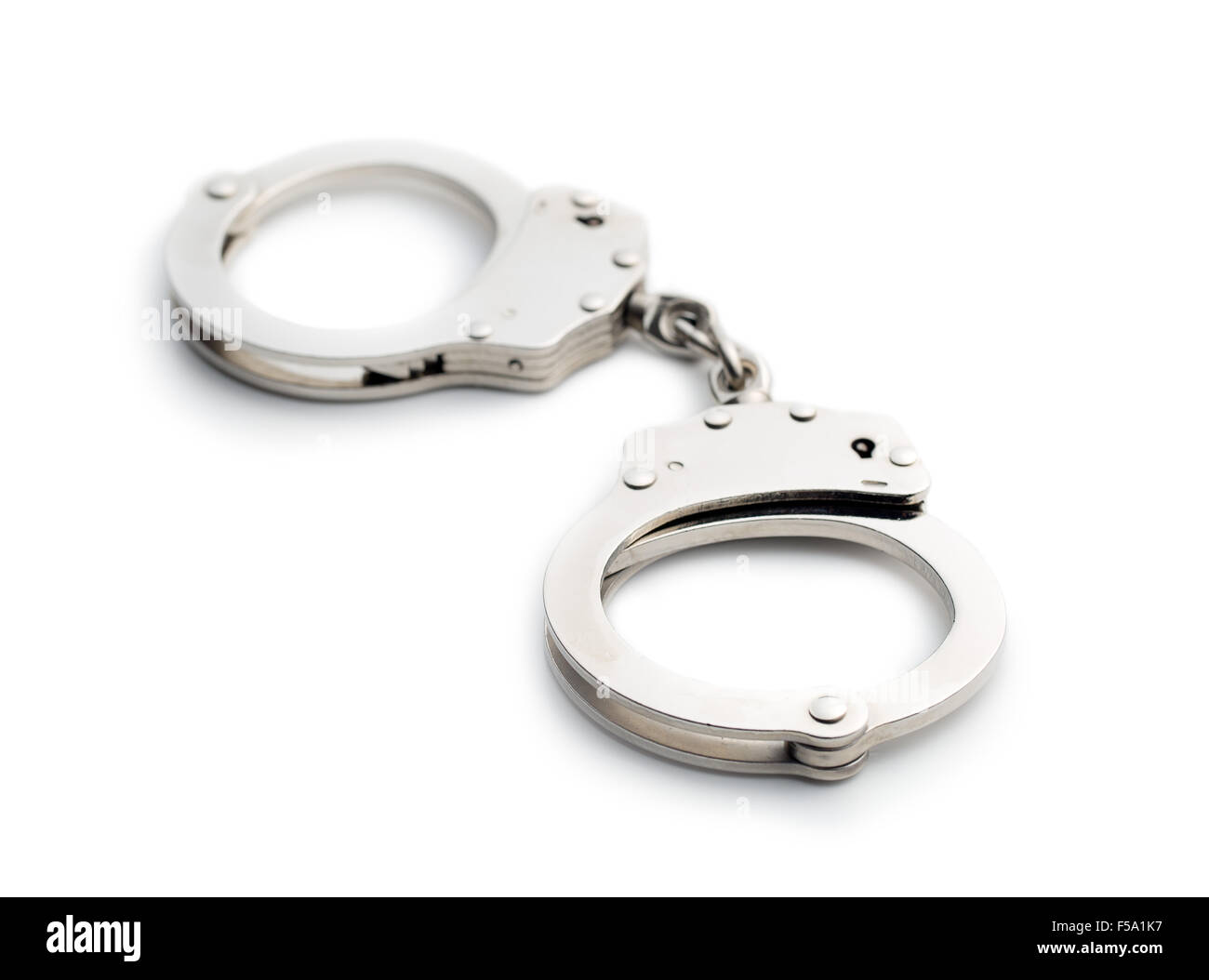 silver handcuffs on white background Stock Photo - Alamy