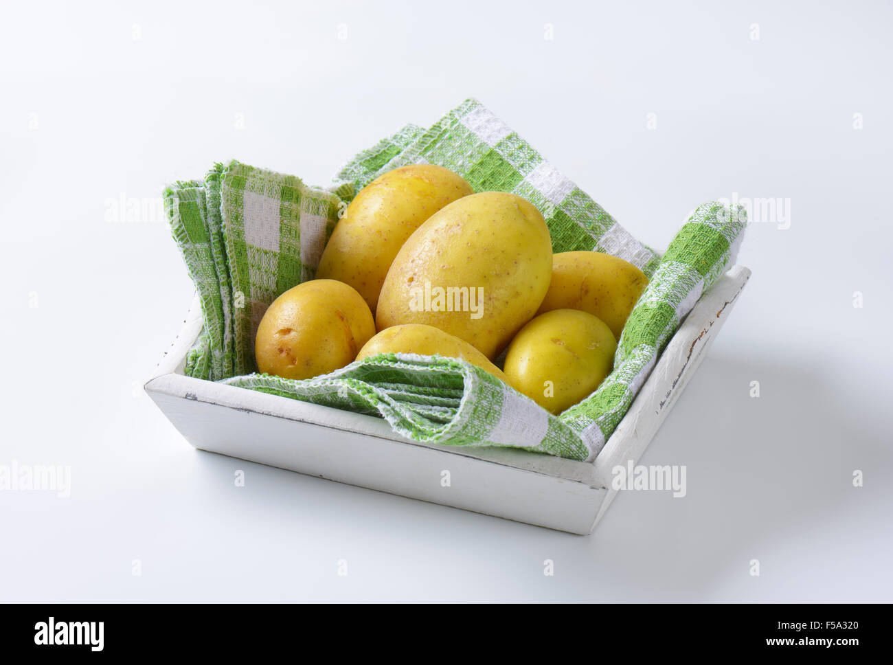 New potatoes in white wooden tray Stock Photo - Alamy