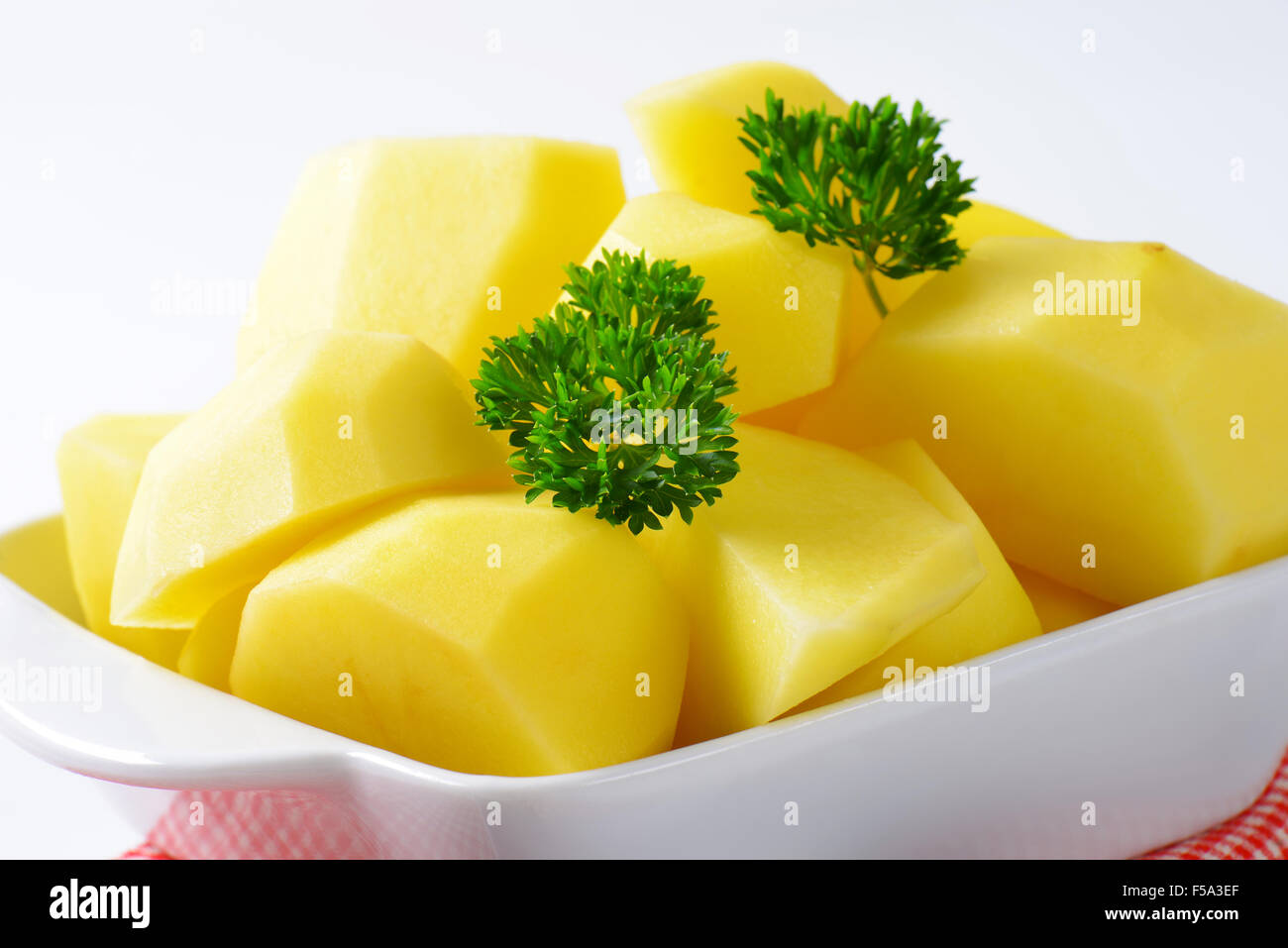 Raw peeled potatoes in ceramic dish Stock Photo - Alamy