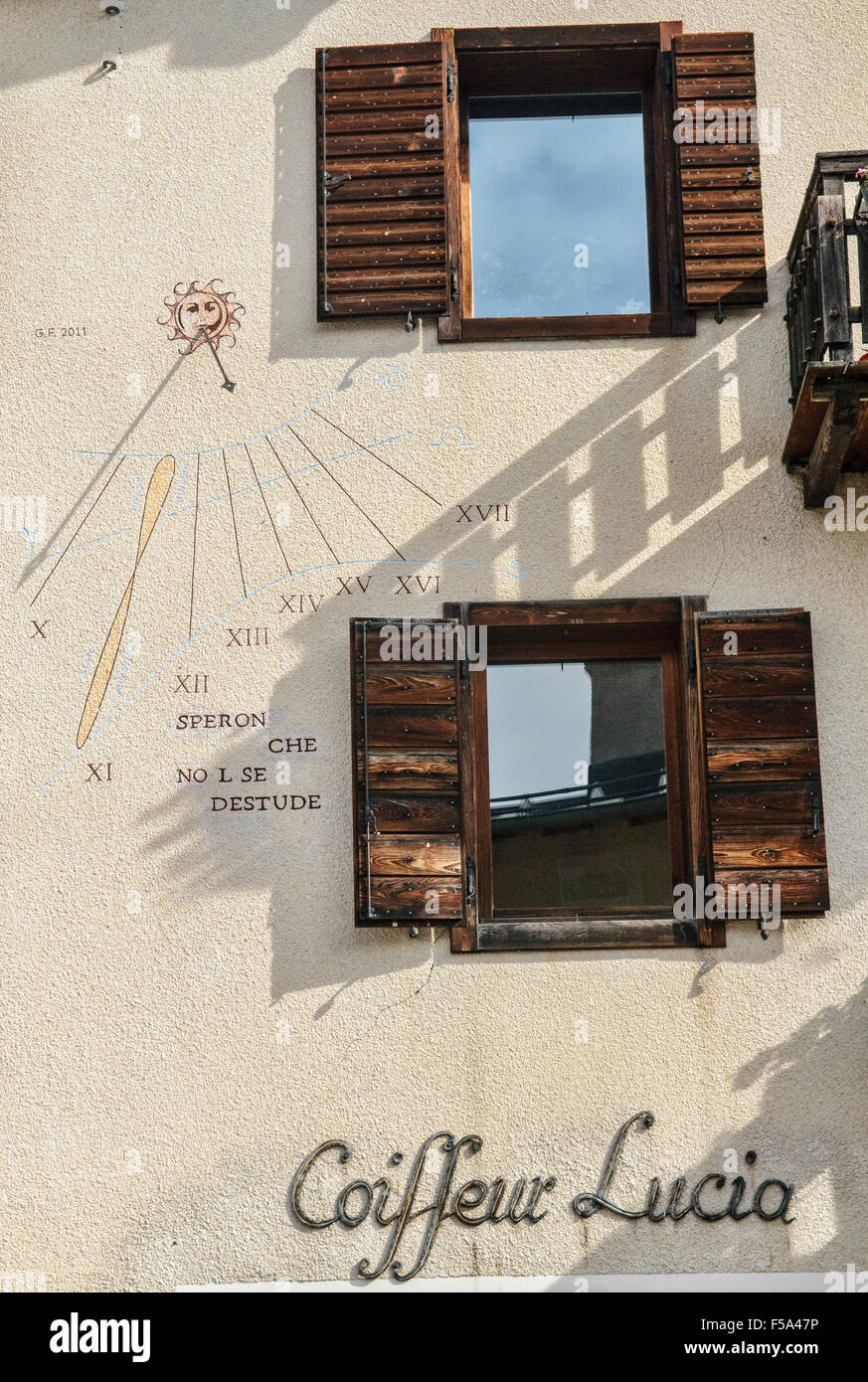 Sundial on top of a salon in Colle Santa Lucia in the Dolomites, Italy ...