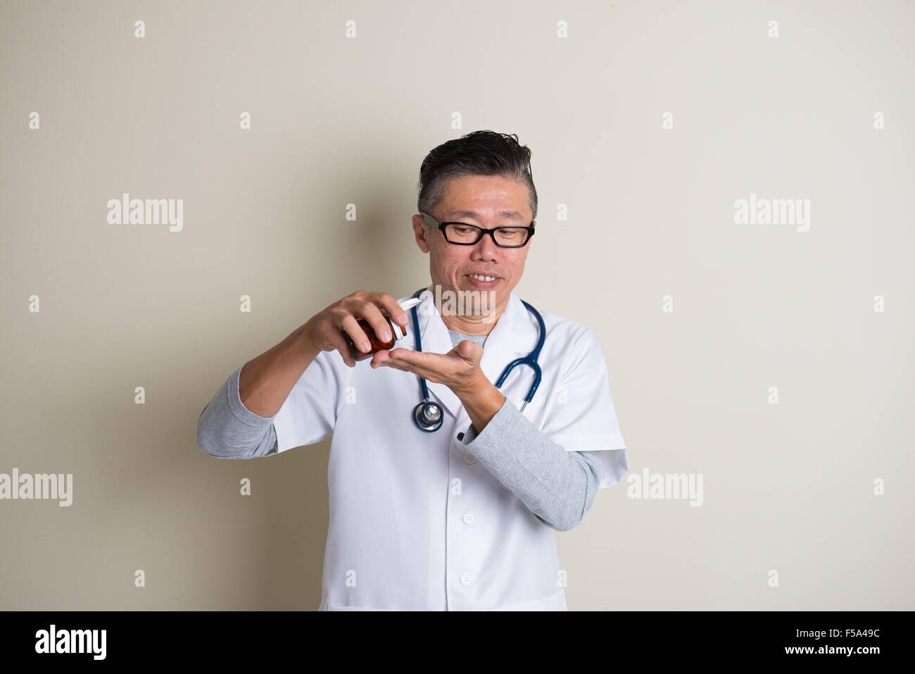 Asian doctor with medicine Stock Photo - Alamy