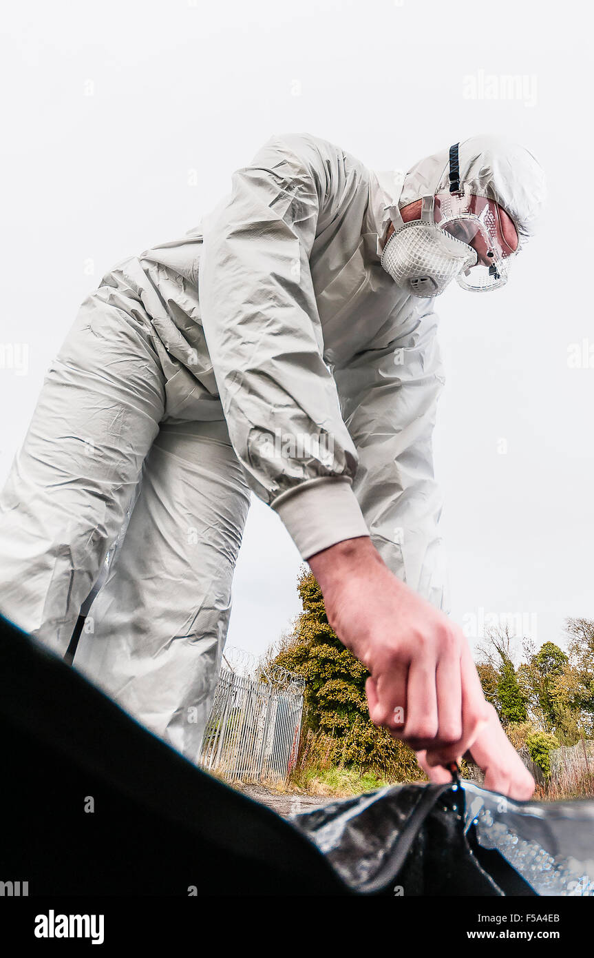 A Scene of Crime Officer (SOCO) wearing protective mask and goggles ...