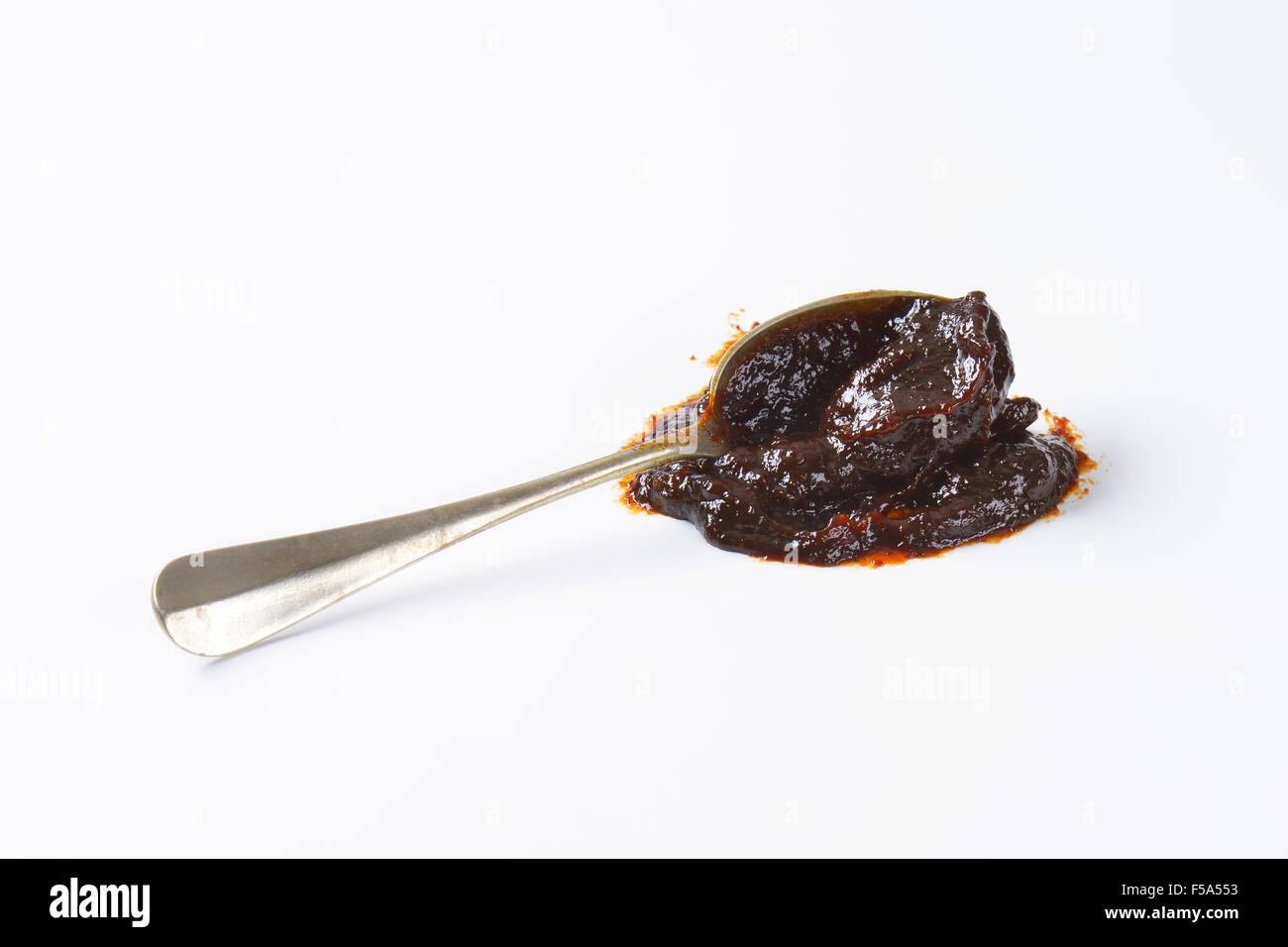 Spoon of plum jam on white background Stock Photo - Alamy