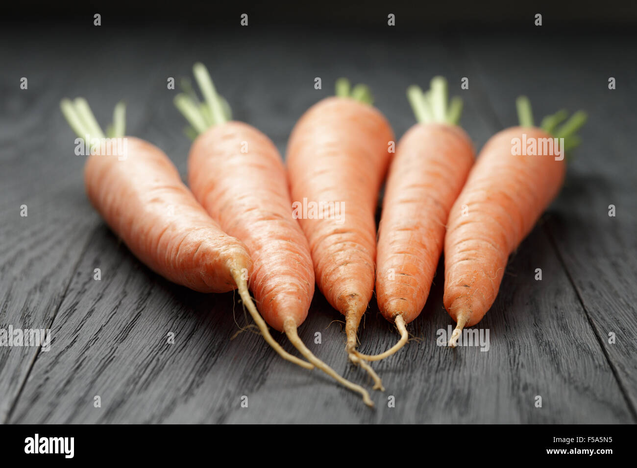 fresh carrots on old oak table Stock Photo - Alamy