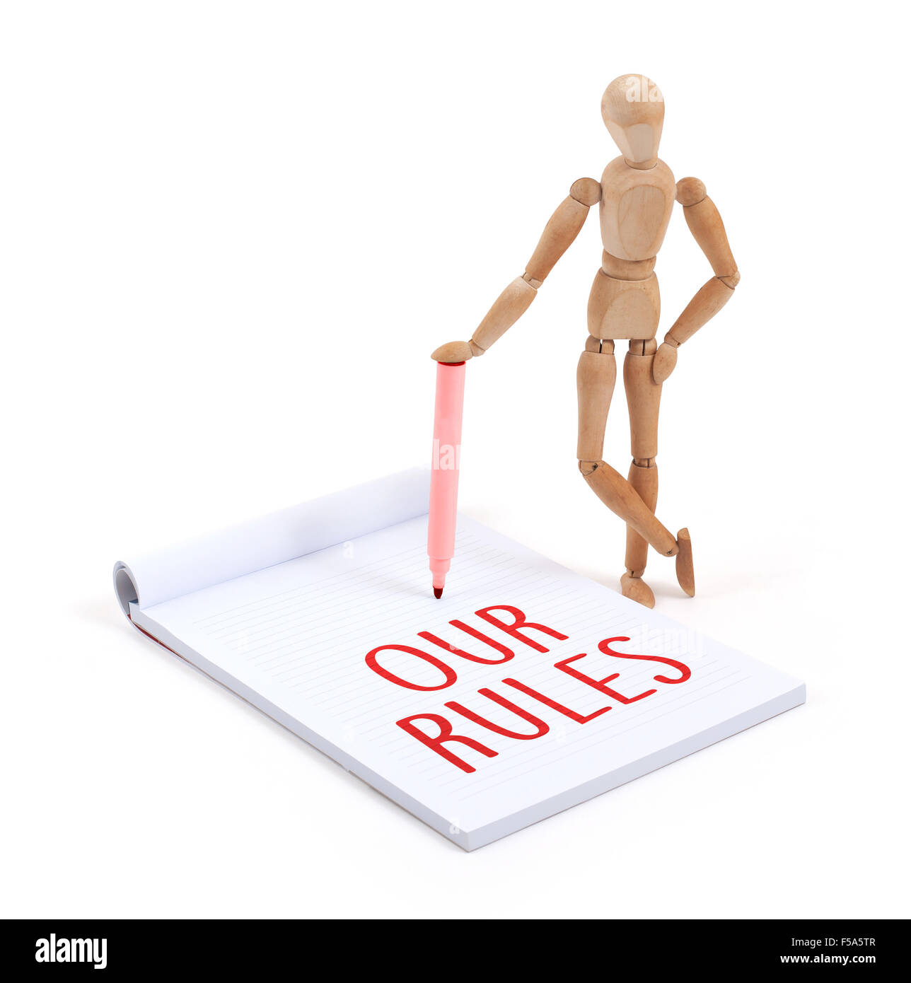 Wooden mannequin writing in a scrapbook - Our rules Stock Photo - Alamy