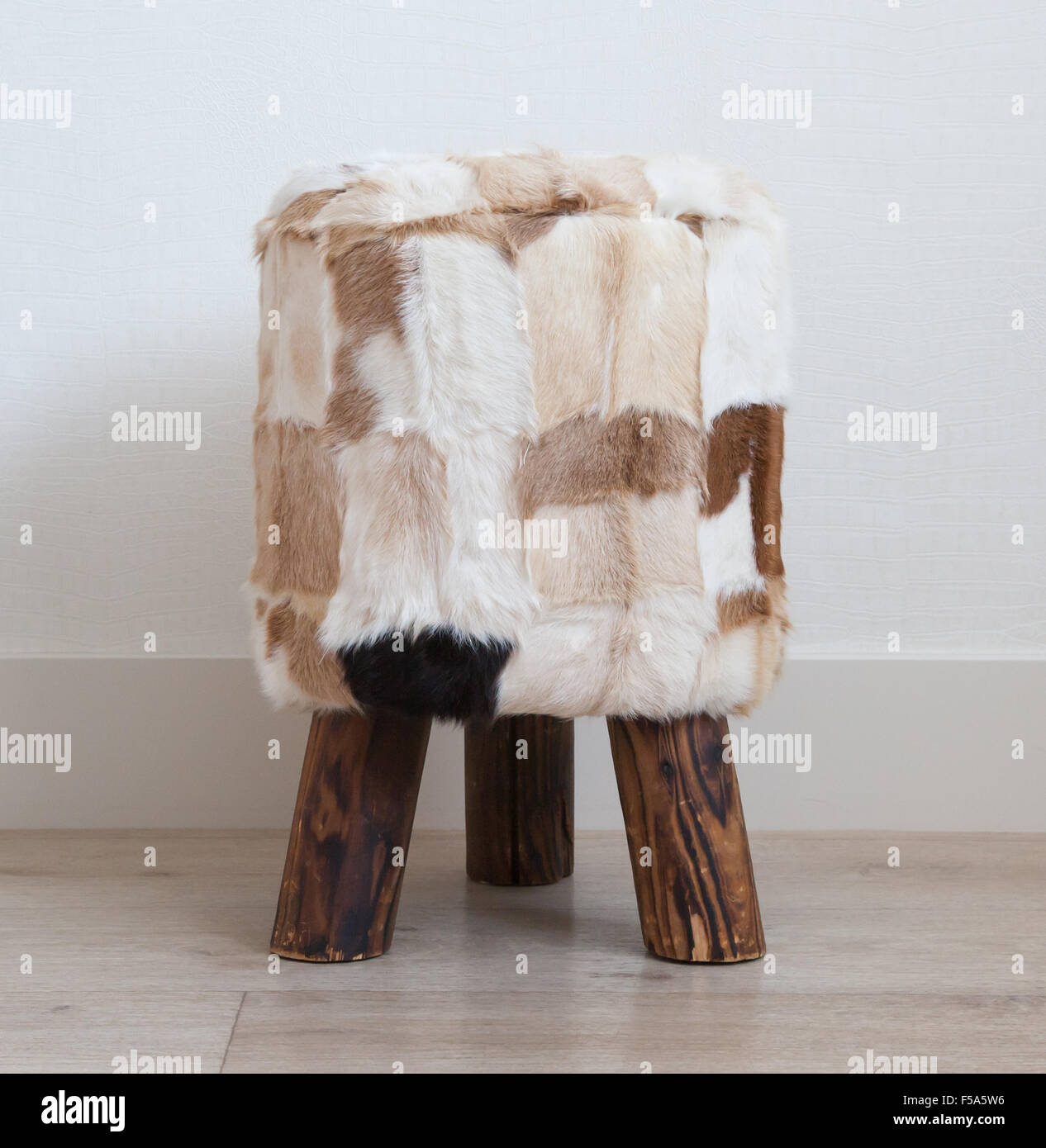 Small stool made of cowhide and wood Stock Photo - Alamy