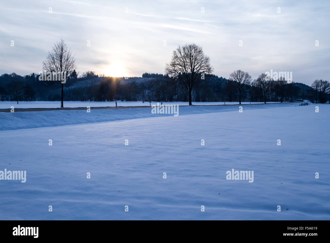 A snowy field at sunset Stock Photo - Alamy