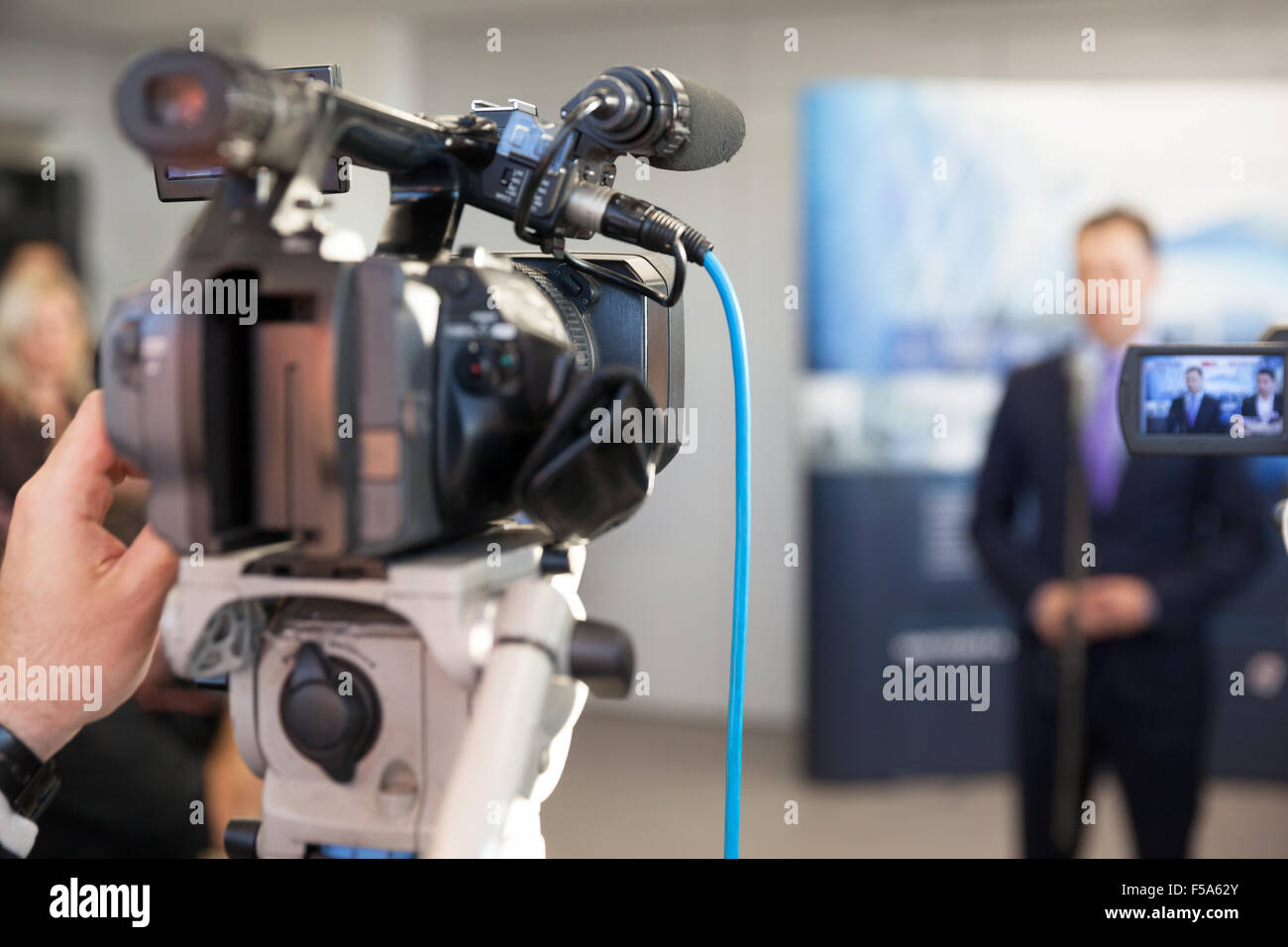 Filming an event with a video camera. Spokesperson Stock Photo - Alamy