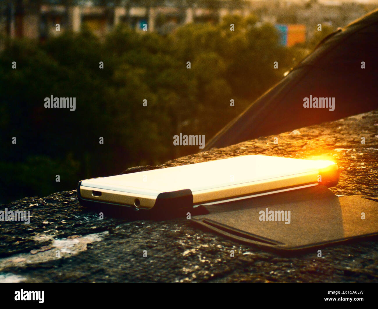 Cell phone placed on a ground Stock Photo - Alamy