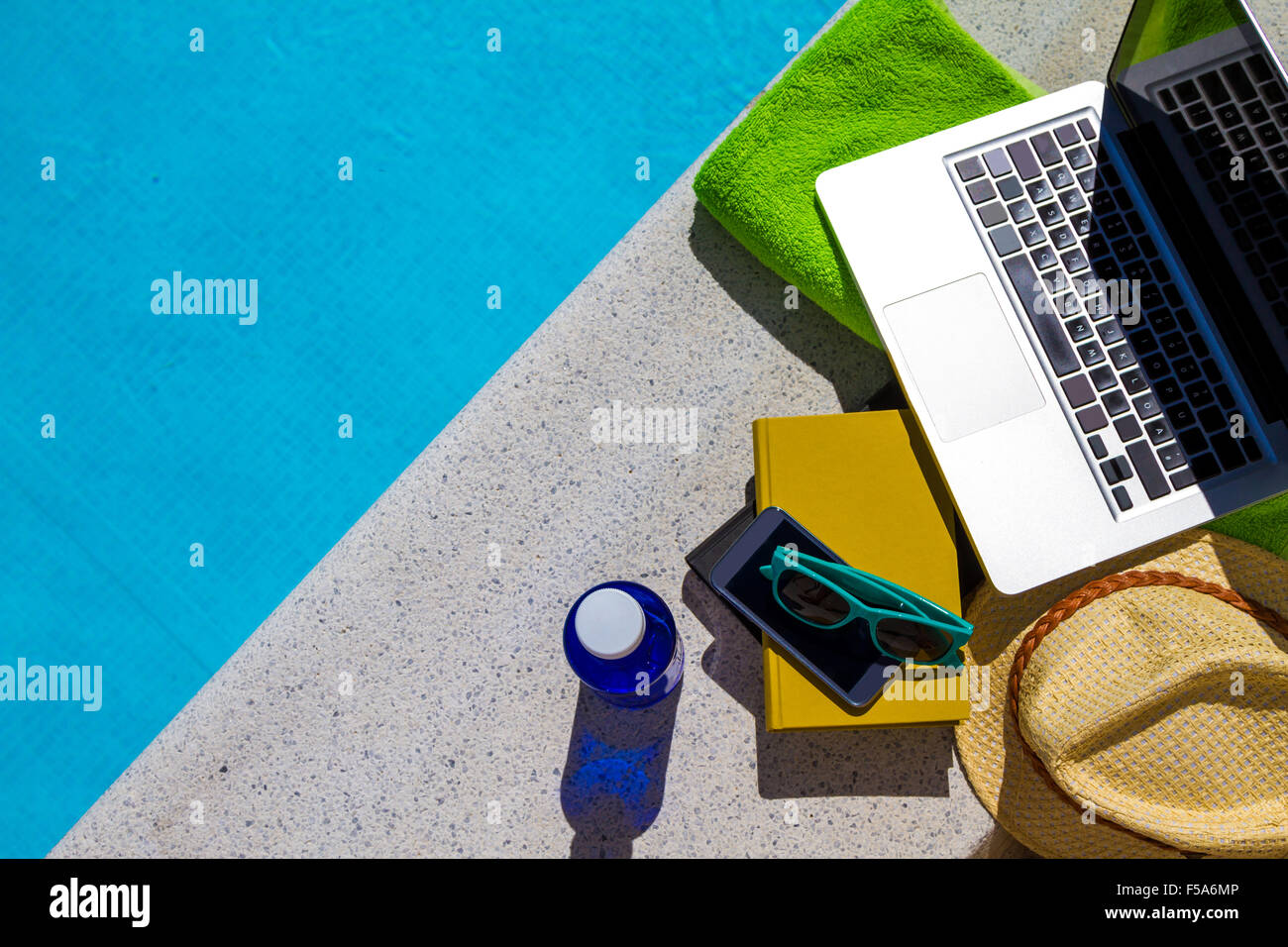 Using a computer by the pool hi-res stock photography and images - Alamy