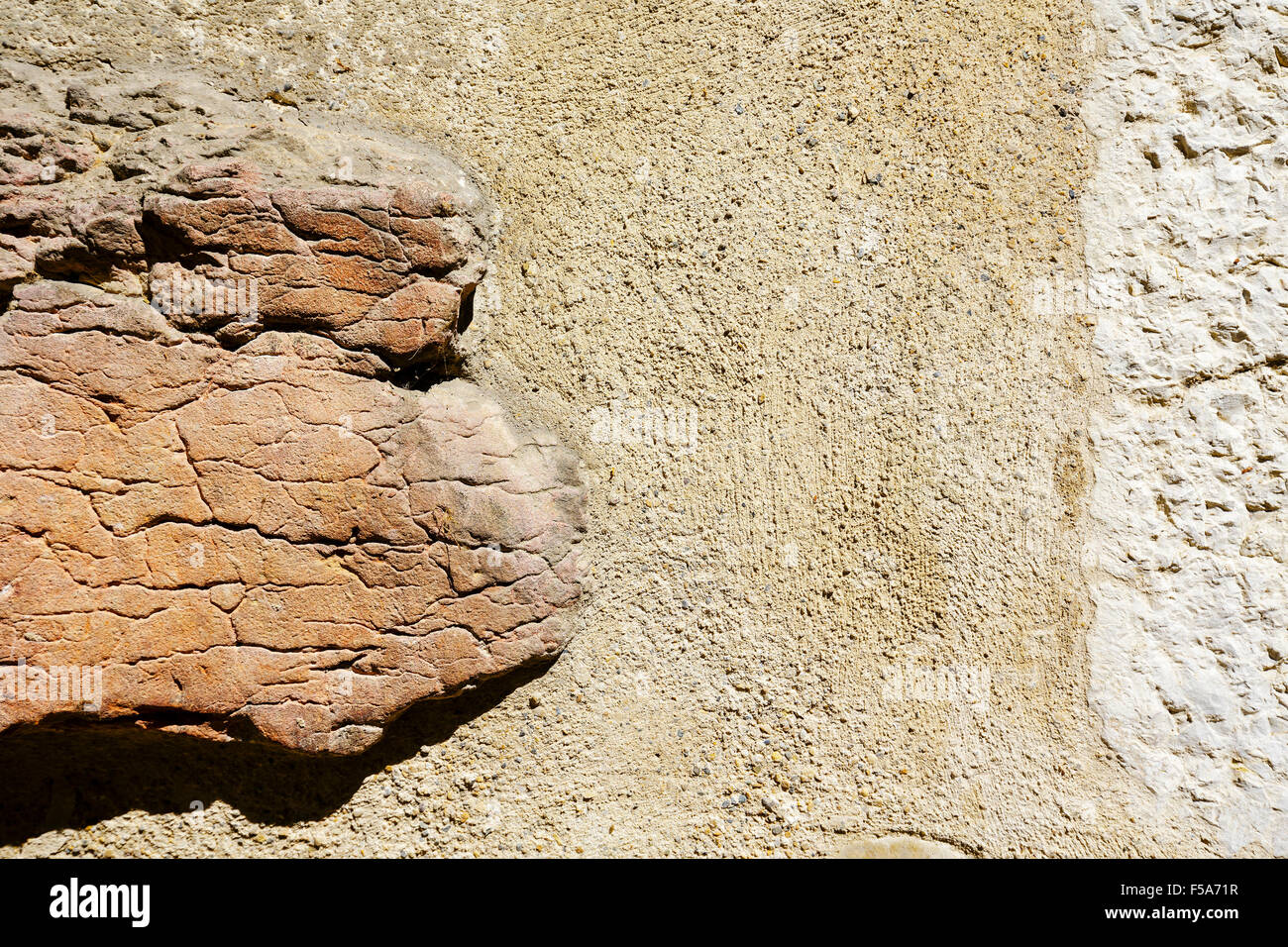 Old wall and protruding rock Stock Photo - Alamy