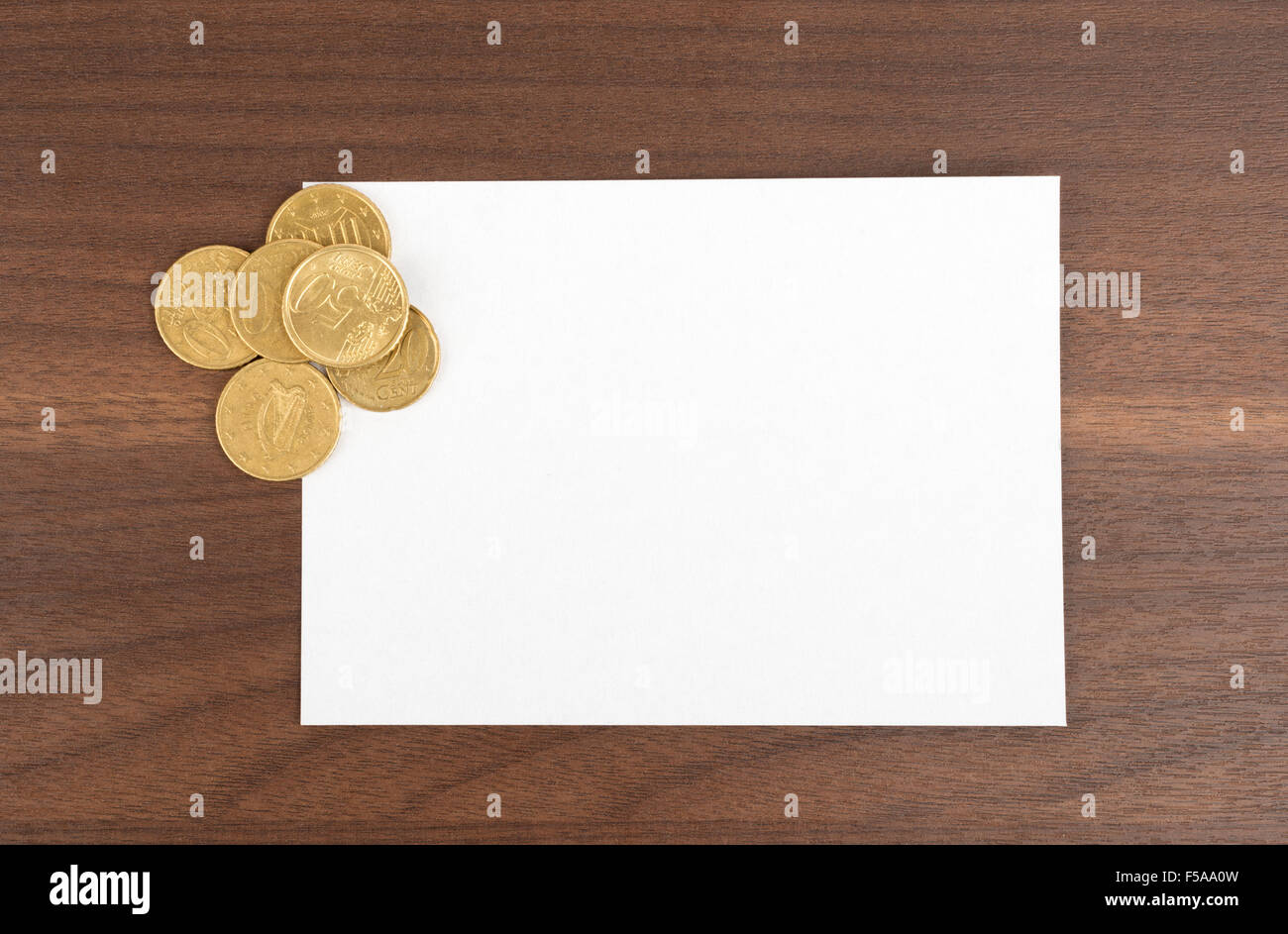 Blank card with golden coins Stock Photo - Alamy
