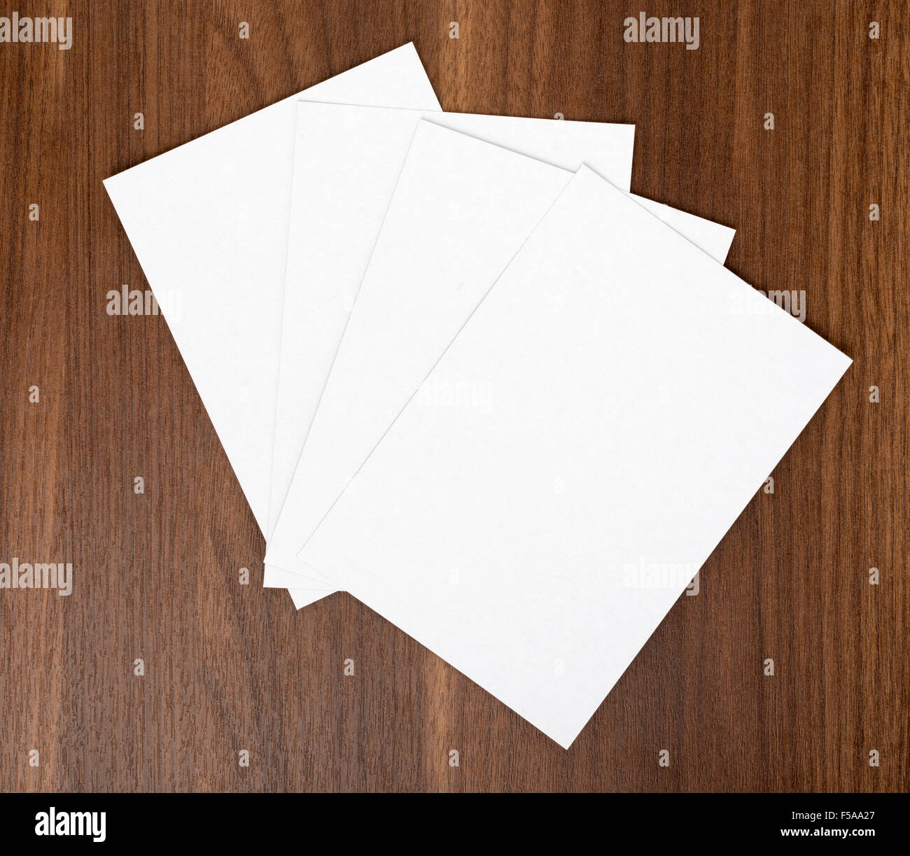 Four blank cards on wood table, top view Stock Photo - Alamy