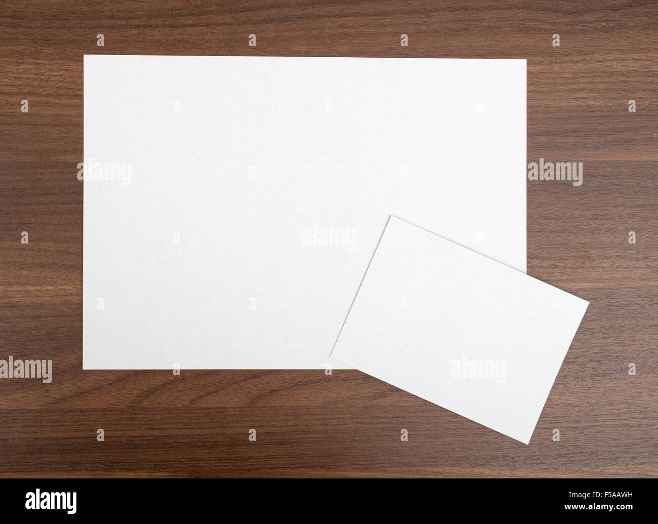 Several blank sheets on wood table Stock Photo - Alamy