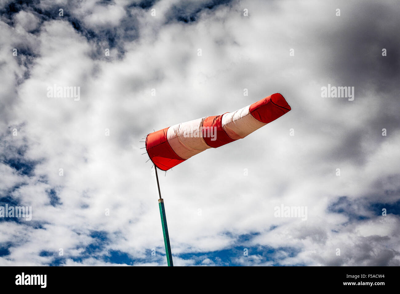 Windsock the cloudy sky background. Wind southwest Stock Photo - Alamy