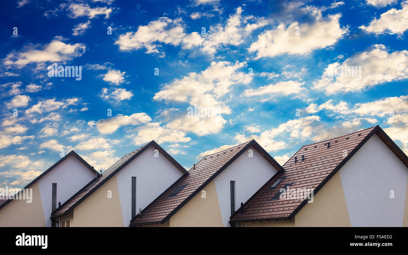 Residential homes in a straight line with a cloudy sky Stock Photo - Alamy