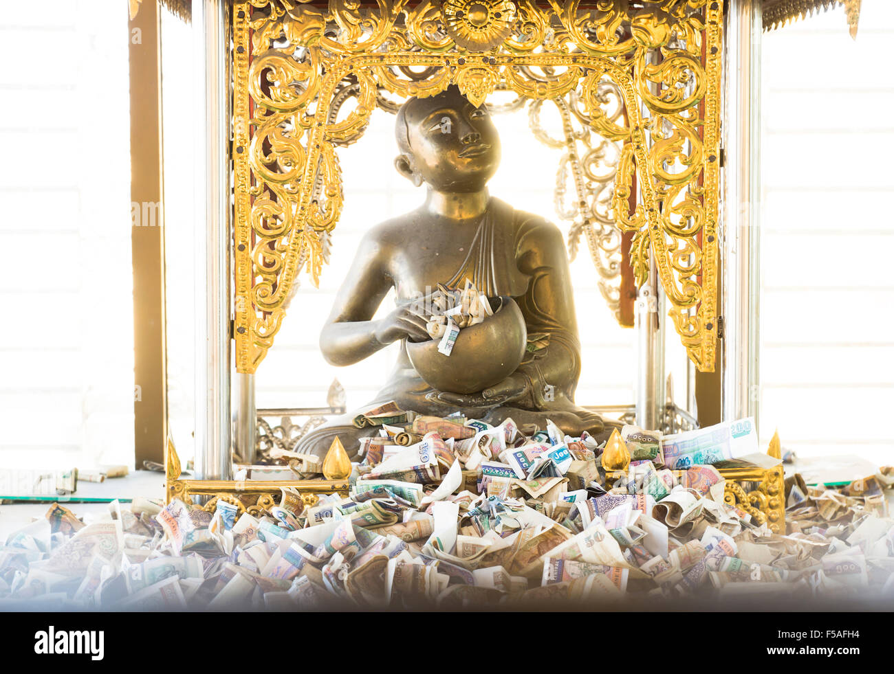 Sacrifices to buddha statue, Myanmar Stock Photo - Alamy