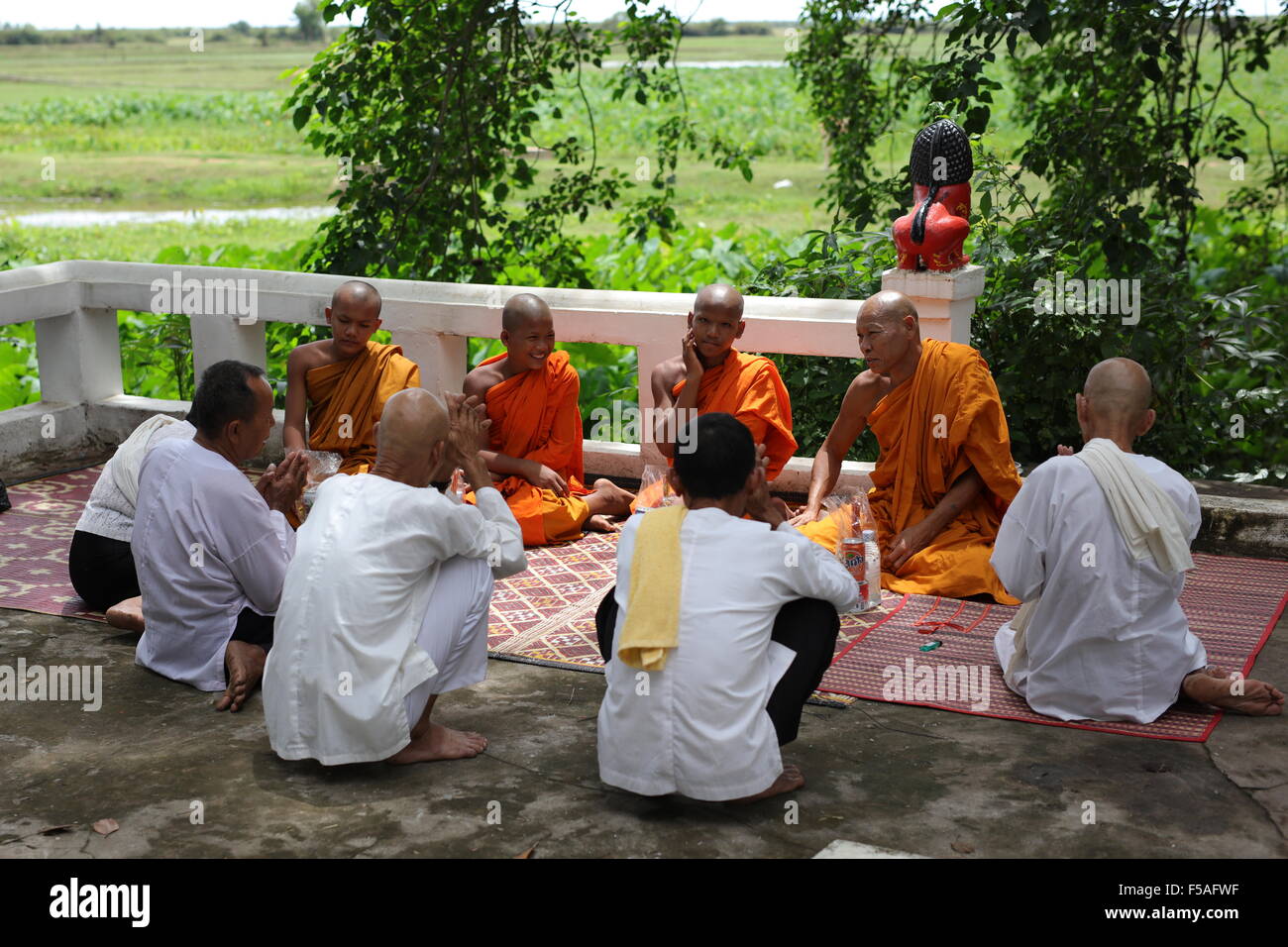 Monks sitting with family Stock Photo - Alamy