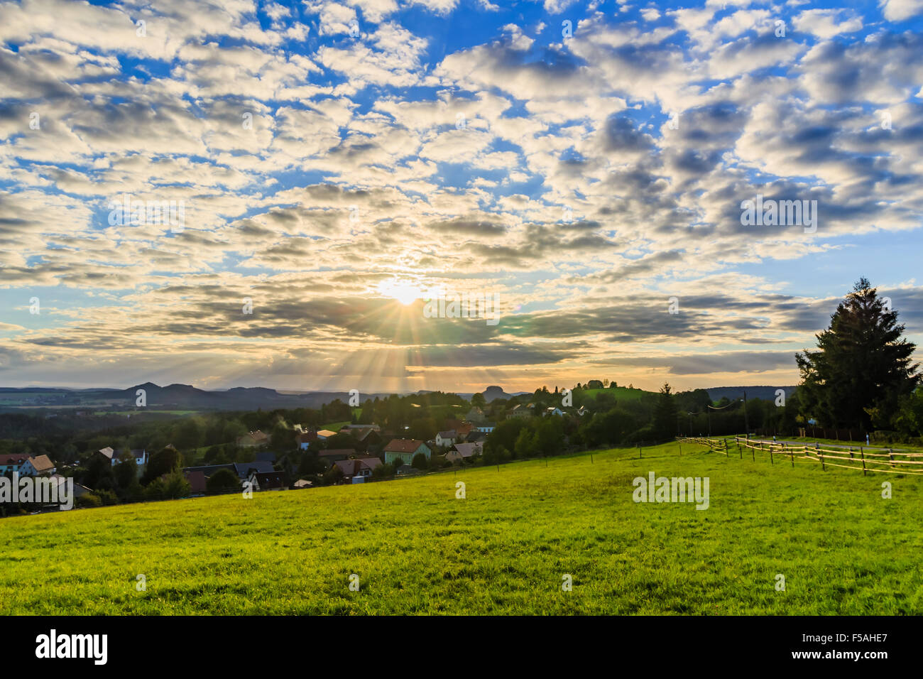 Beautiful sunset over countryside landscape of rolling hills with sun ...
