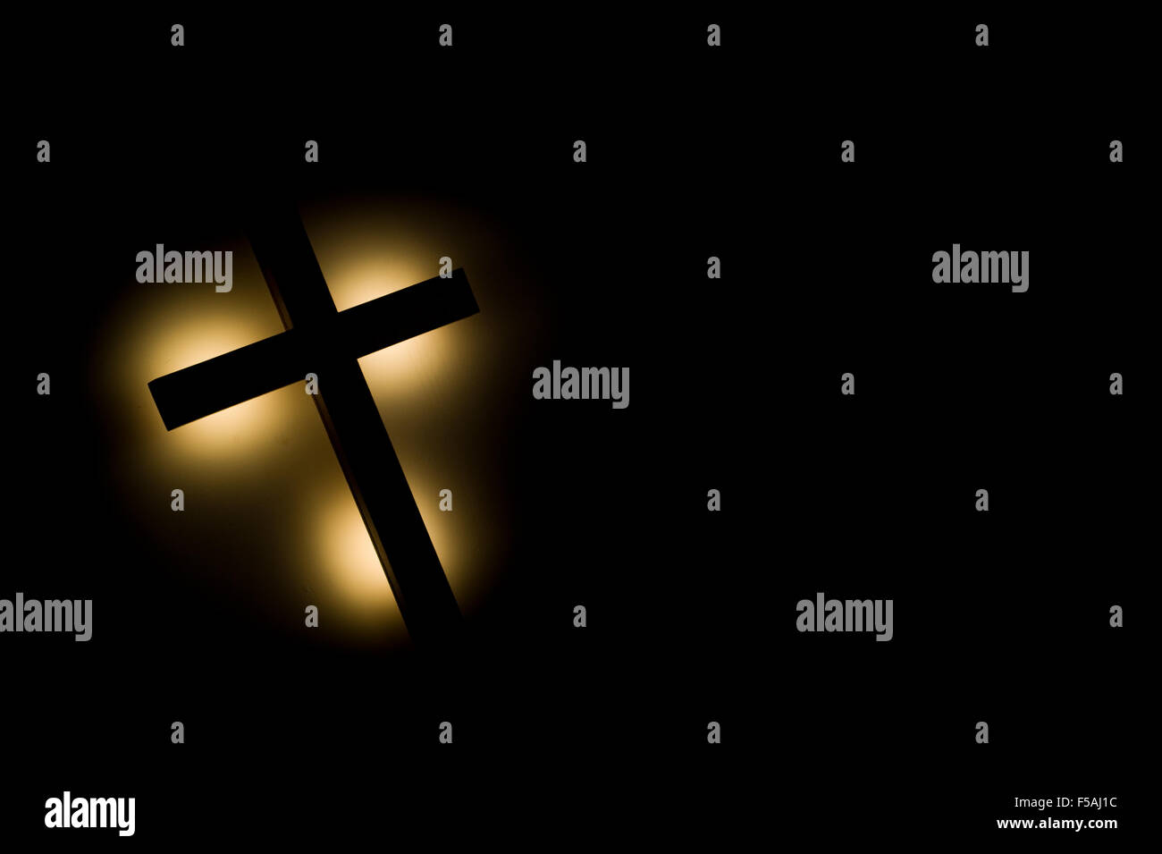 cross with light shining from behind. Ideal for churches Stock Photo ...