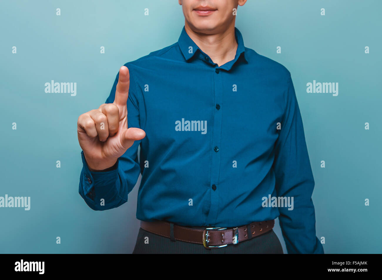 a man can be seen half-face shows a finger on a gray backgrou Stock ...