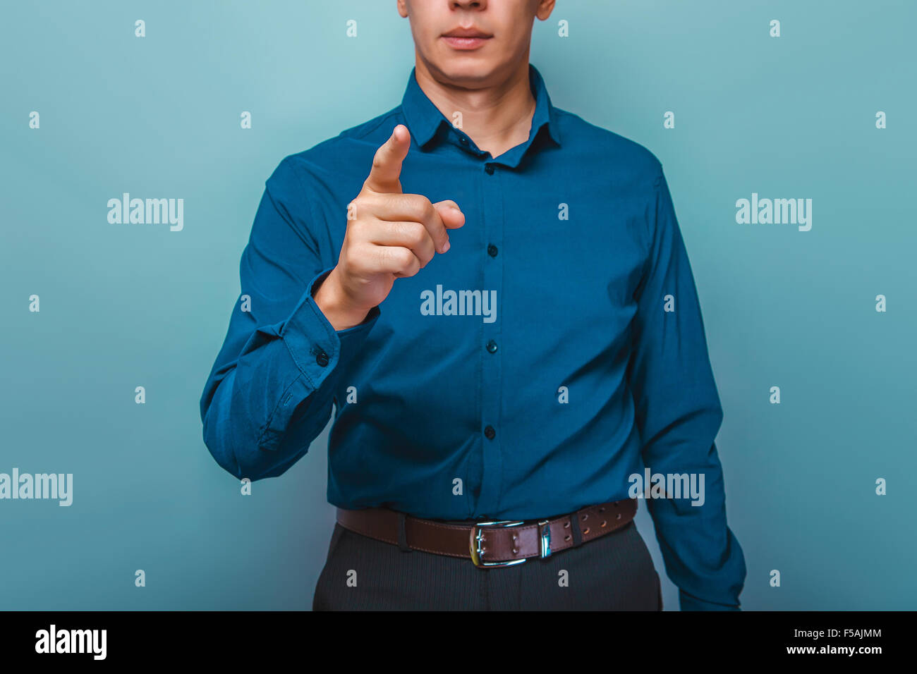 a man can be seen half-face shows a finger on a gray backgroun Stock ...