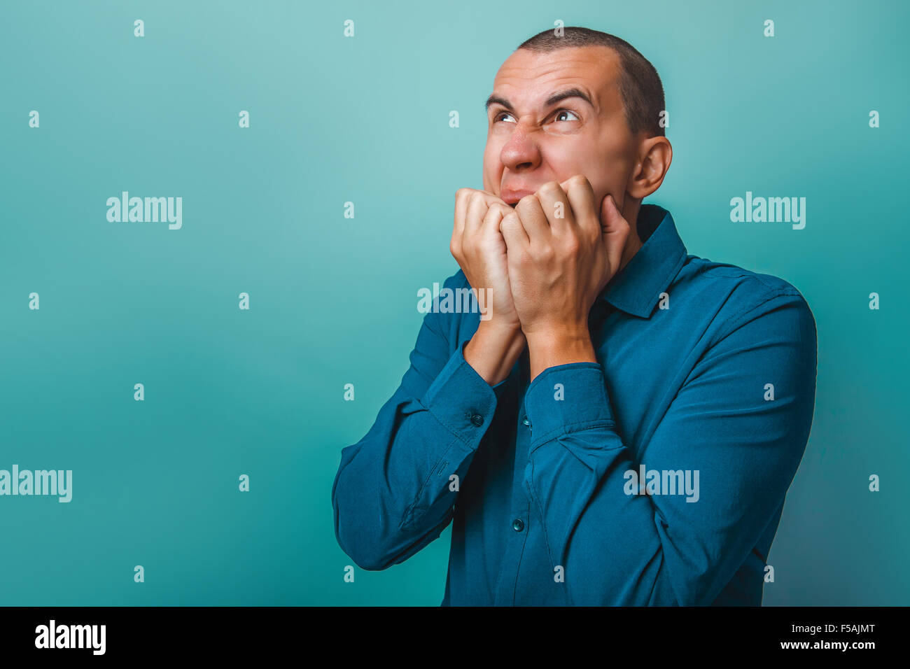 a man of European appearance thirty years chewing fingernails o Stock ...