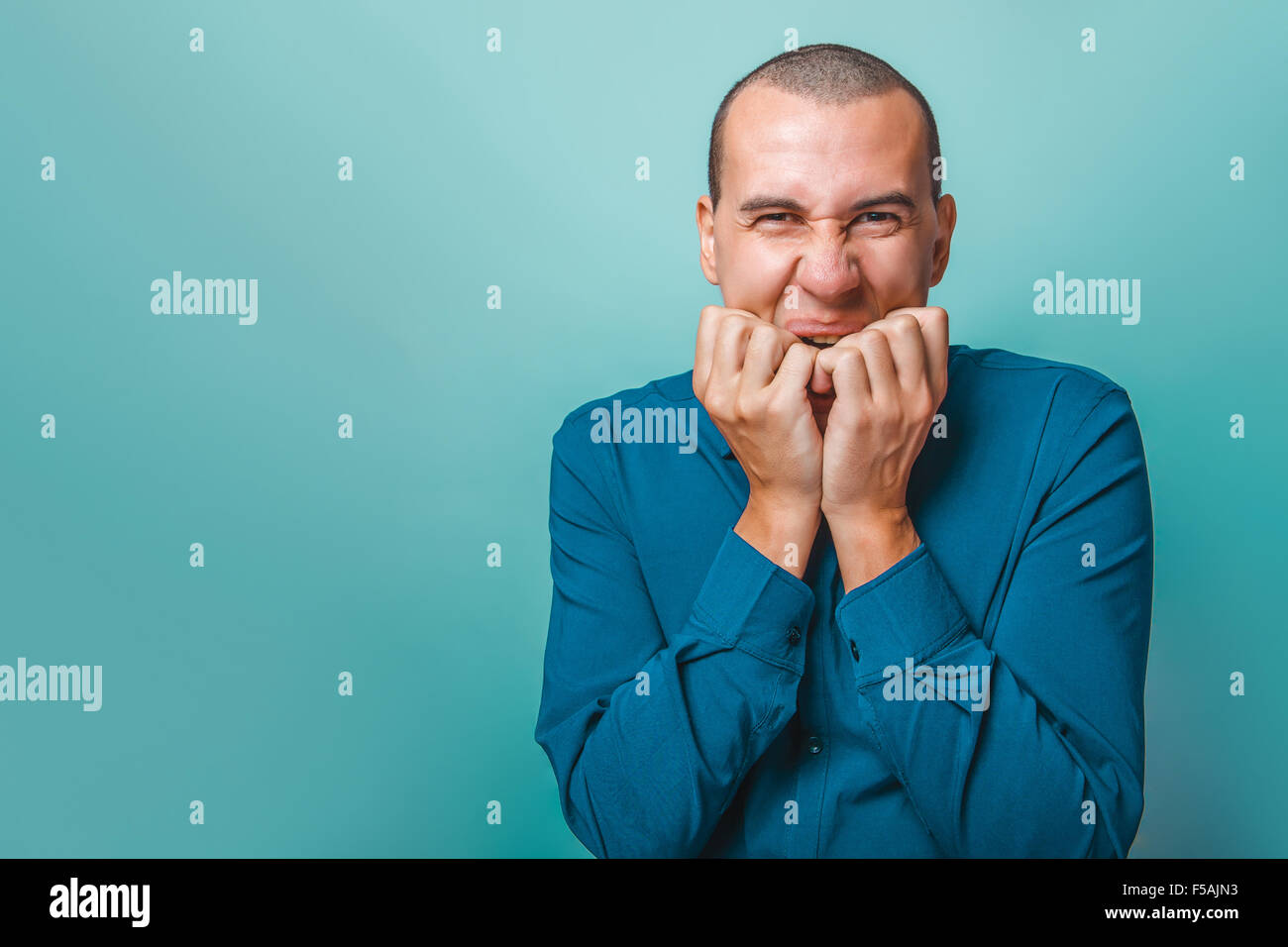 a man of European appearance thirty years chewing fingernails on Stock ...