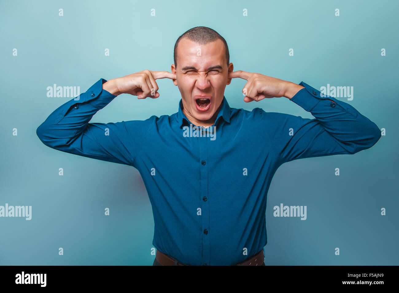 a man of thirty years of European appearance fingers covering hi Stock ...