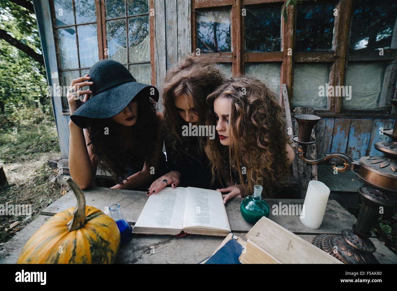 Three vintage witches perform magic ritual Stock Photo - Alamy