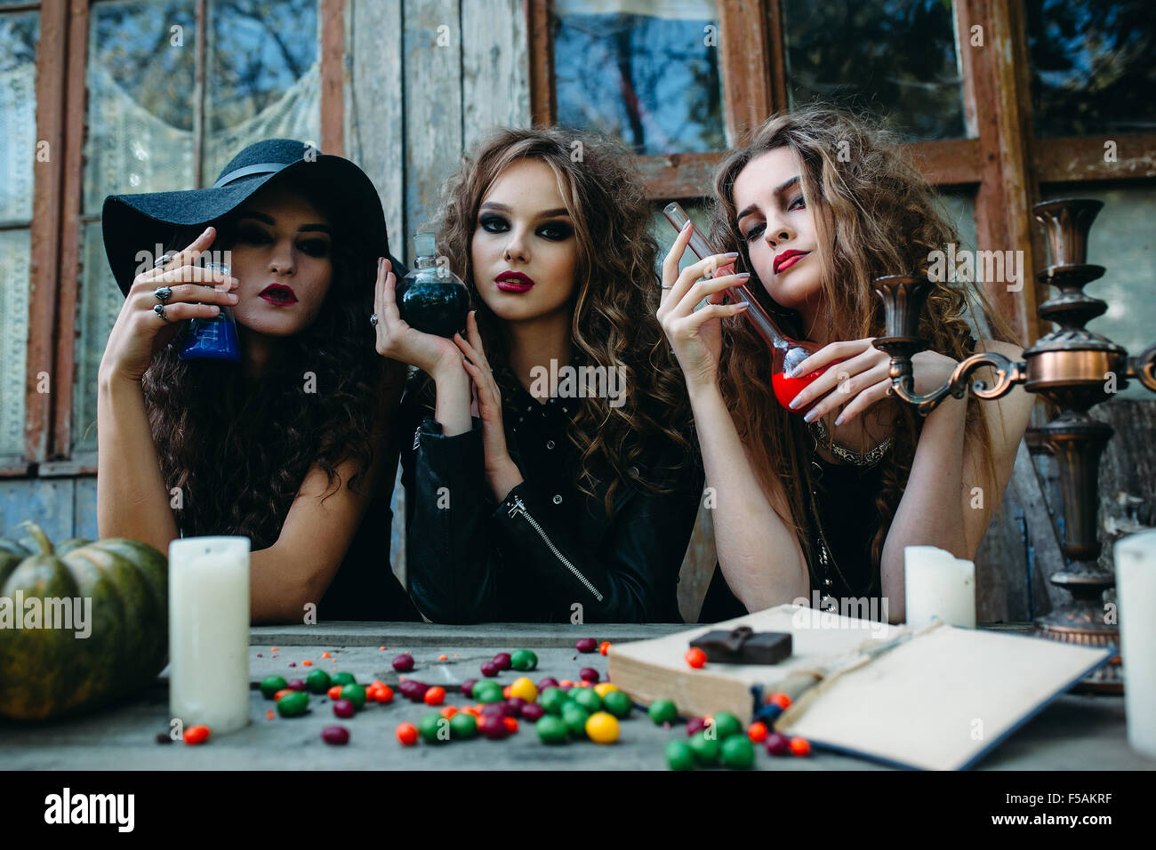 three witches at the table Stock Photo - Alamy