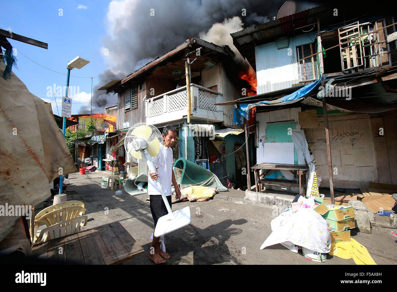 Beijing, Philippines. 29th Oct, 2015. A resident moves his belongings ...