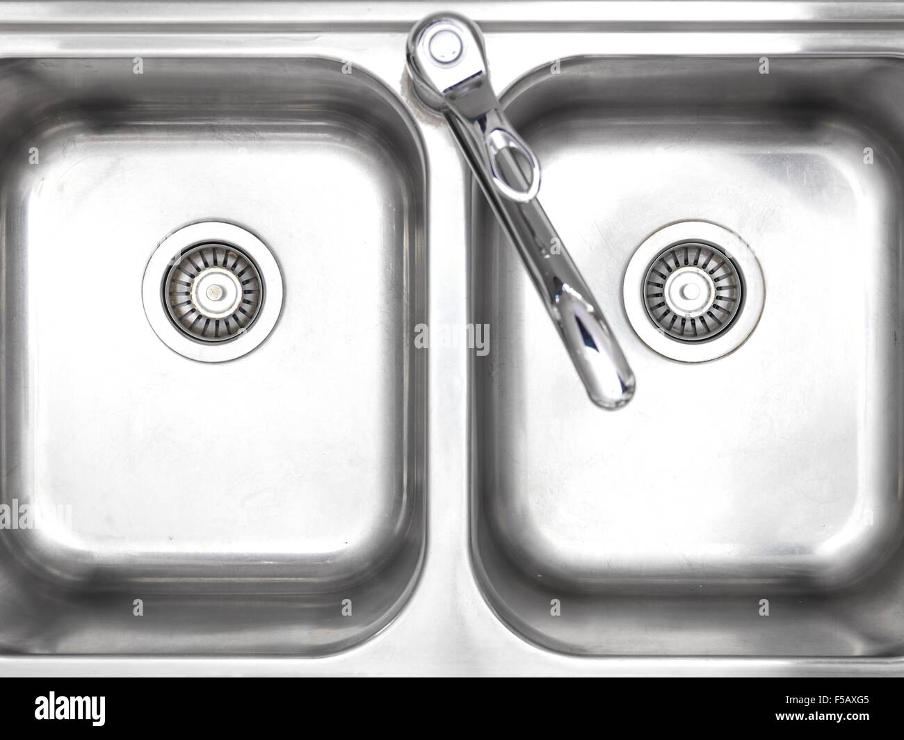 A close up photo of double kitchen sink Stock Photo - Alamy