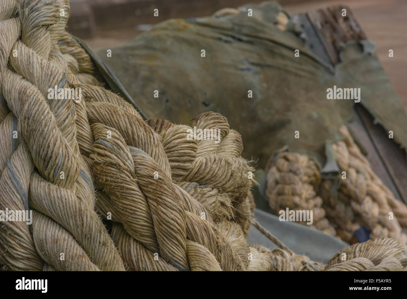 Close-up of natural fibre / fiber / rope hawser on a dock / quay side ...