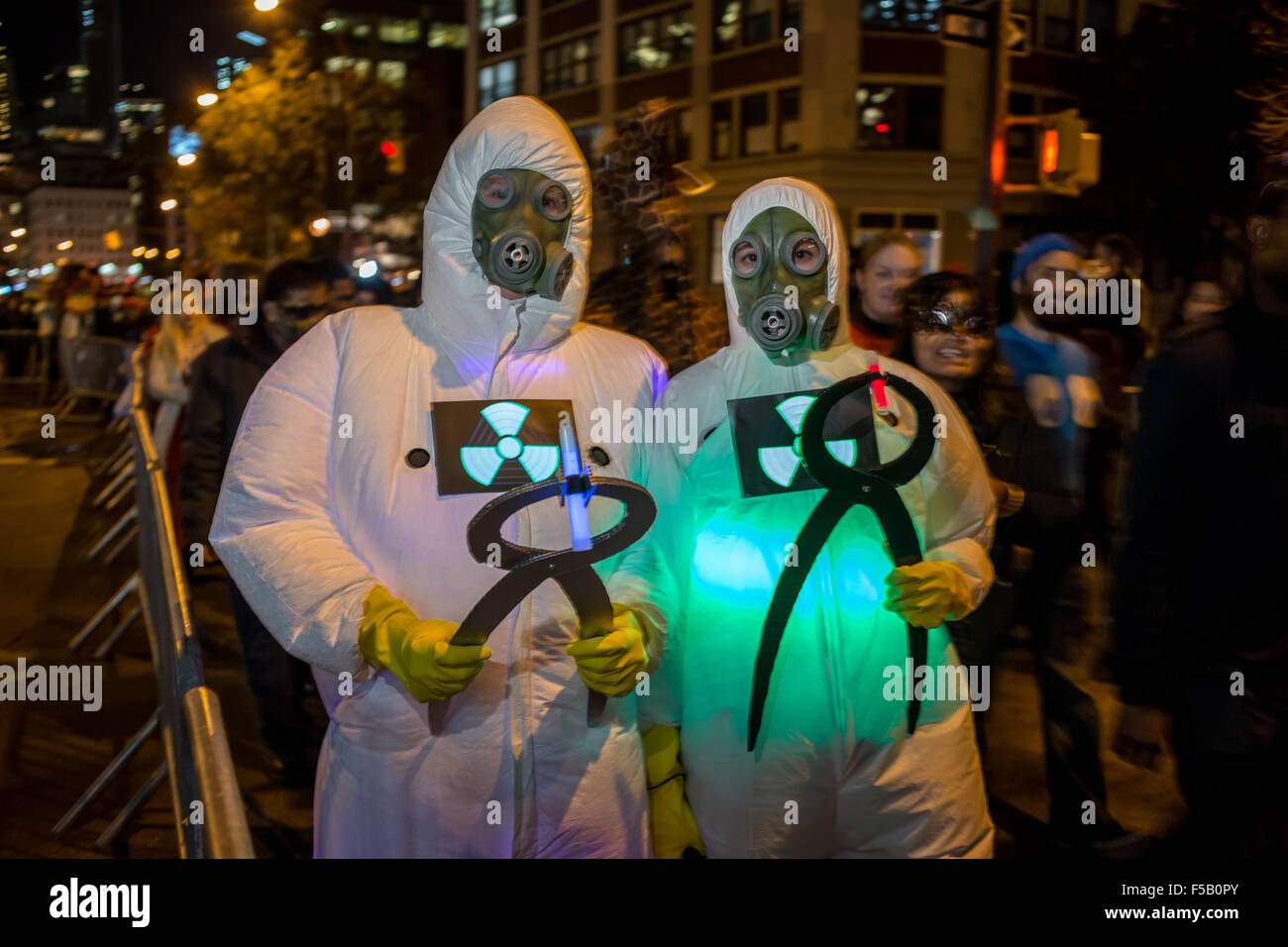 New York, NY - 31 October 2015. A couple with radioactive hazard signs ...