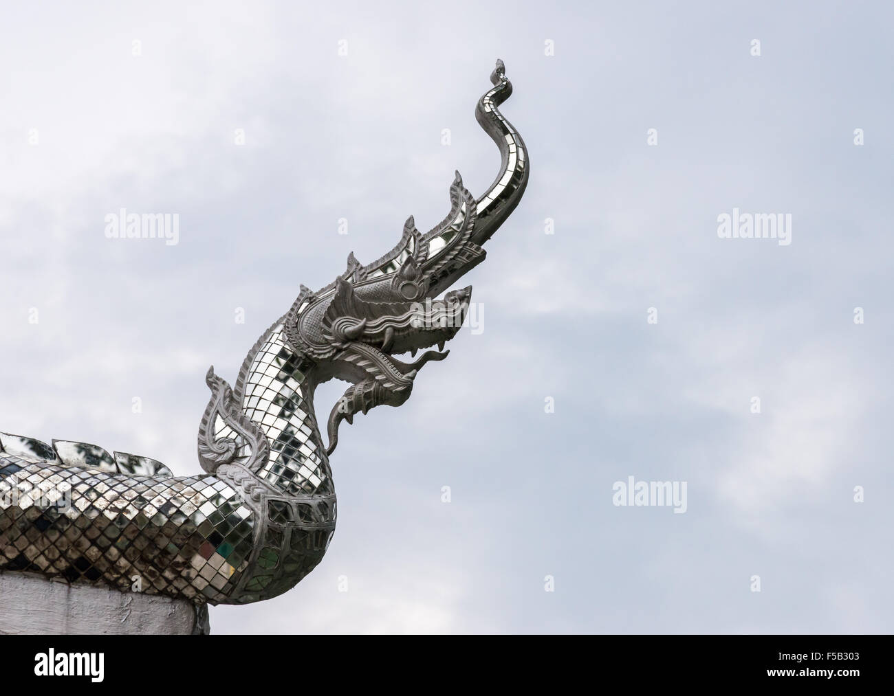 Dragon head sculpture with silver mosaic in the traditional Thai style ...
