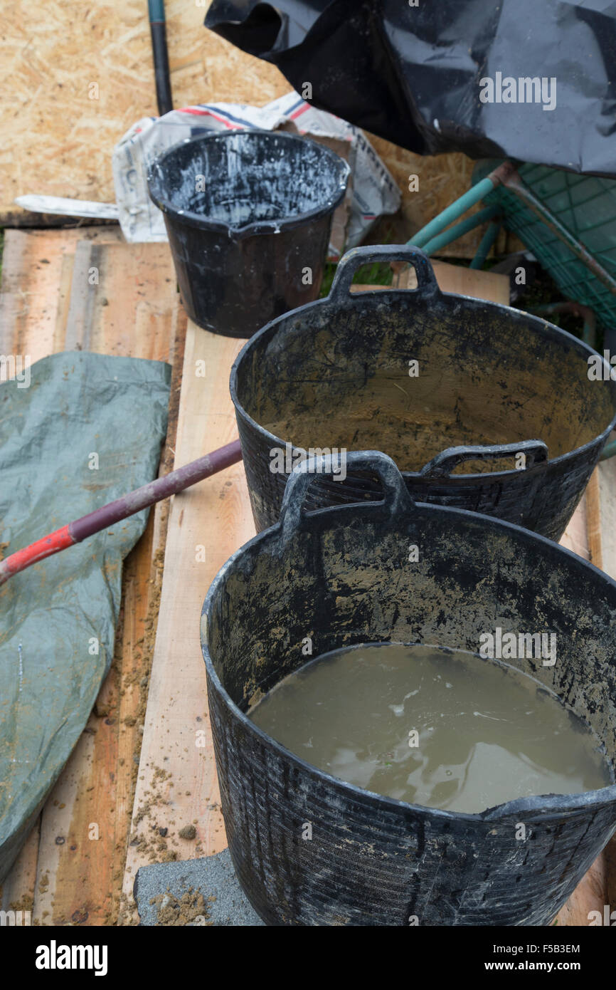 Building site scene with trug buckets of water Stock Photo - Alamy