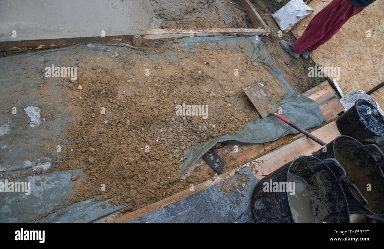 Building site showing a tarpaulin covered in a mixture of sand and ...