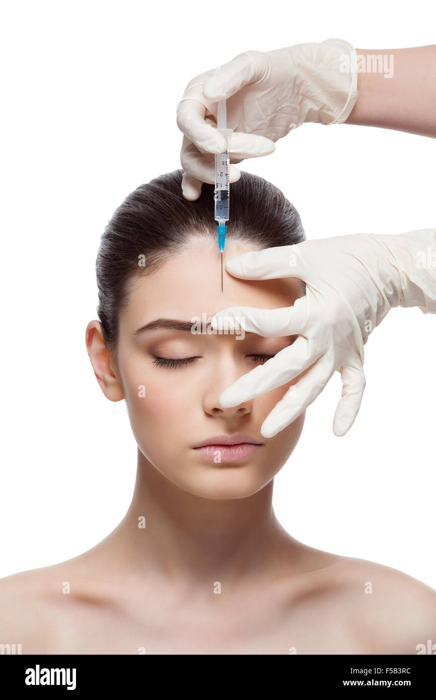 Beautiful young woman gets beauty injection in forehead from sergeant ...