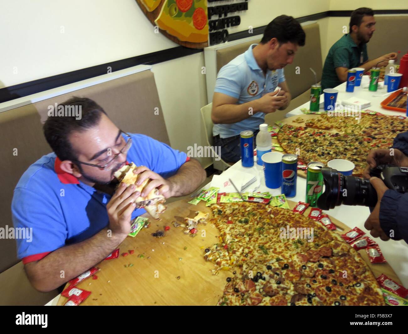 Baghdad, Iraq. 31st Oct, 2015. People attend a contest to eat pizza in ...