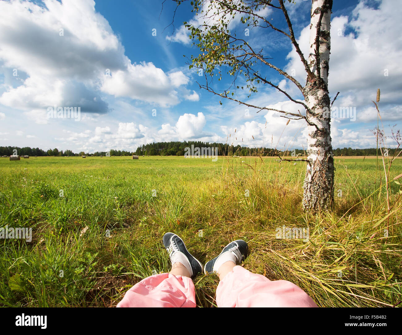 Feet at field with beautiful clouds Stock Photo - Alamy