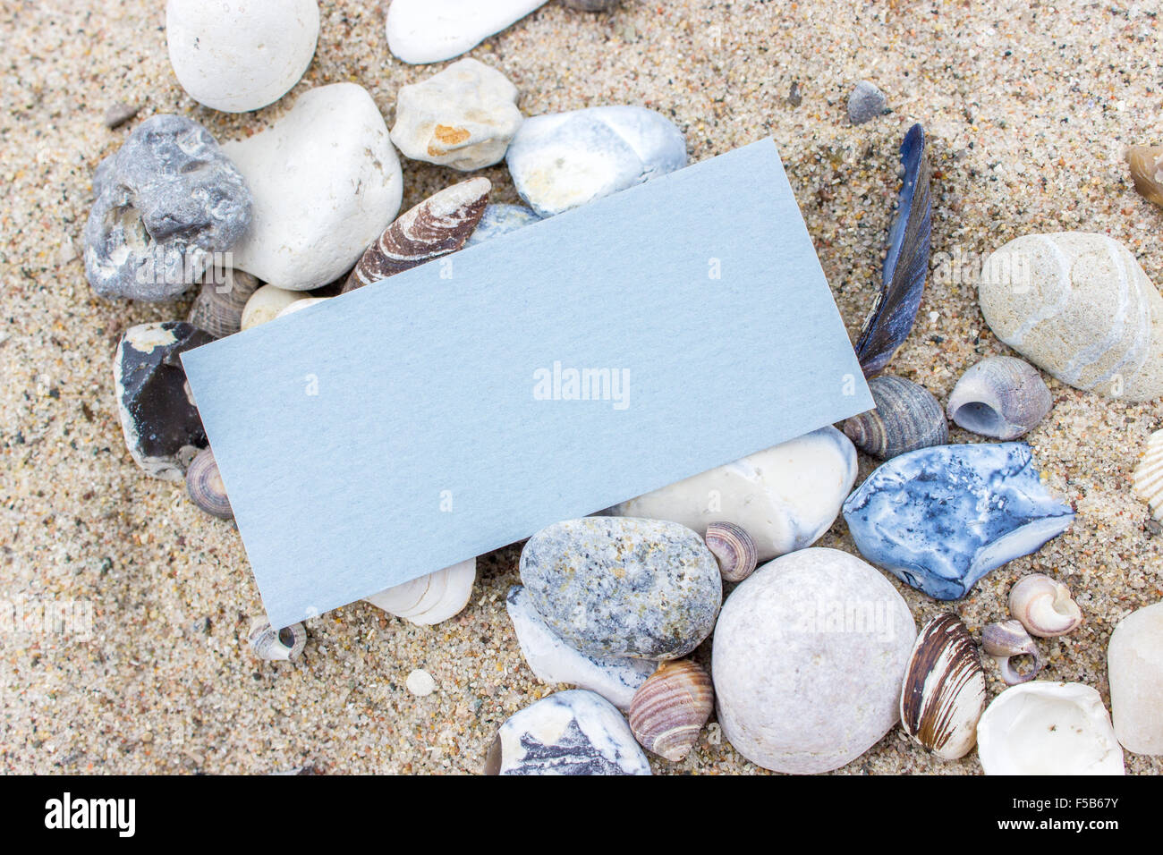 Card, stones and shells in beach sand Stock Photo - Alamy