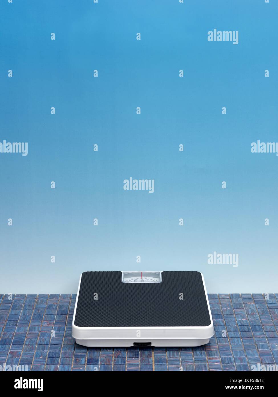 A studio photo of a set of body scales on tiles Stock Photo - Alamy