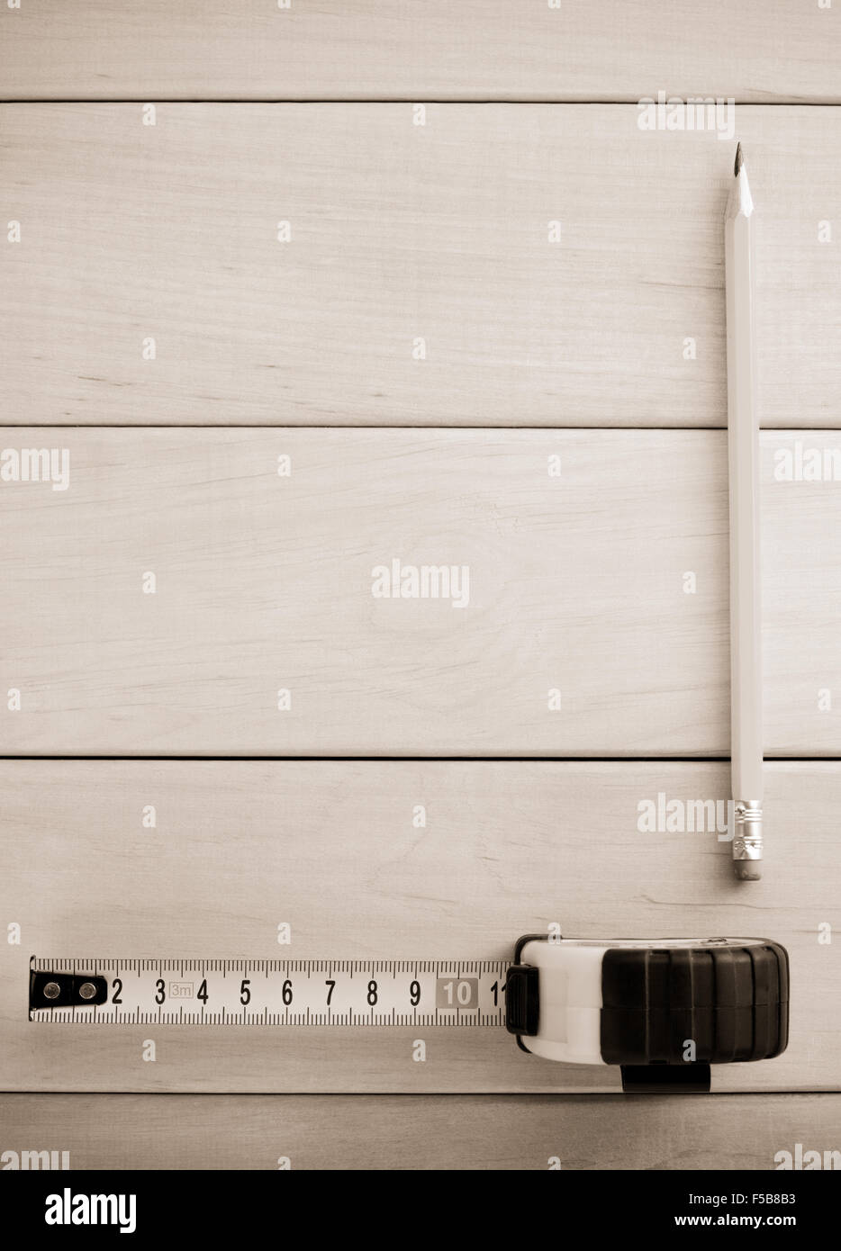 tape measure and pencil on wooden texture Stock Photo - Alamy