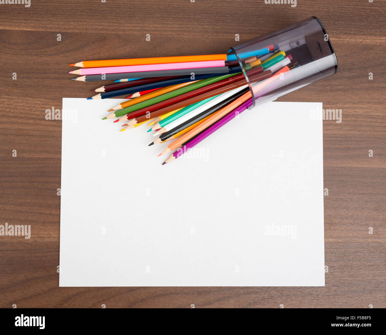Blank paper with crayons on table Stock Photo - Alamy
