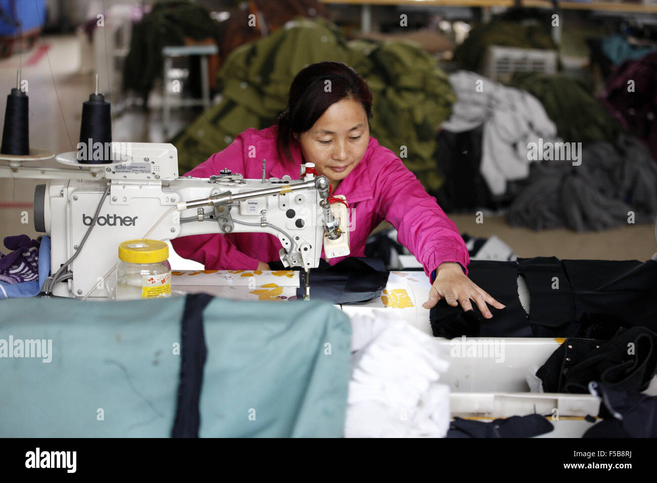 A female labour works in a clothes factory in Huaibei, Anhui province ...