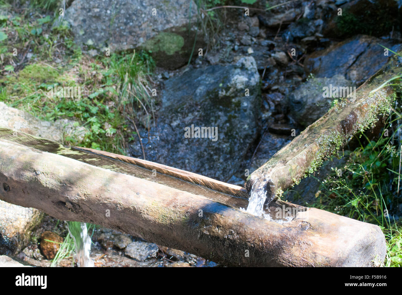 Wooden water ducts transfers water for irrigation Stock Photo - Alamy