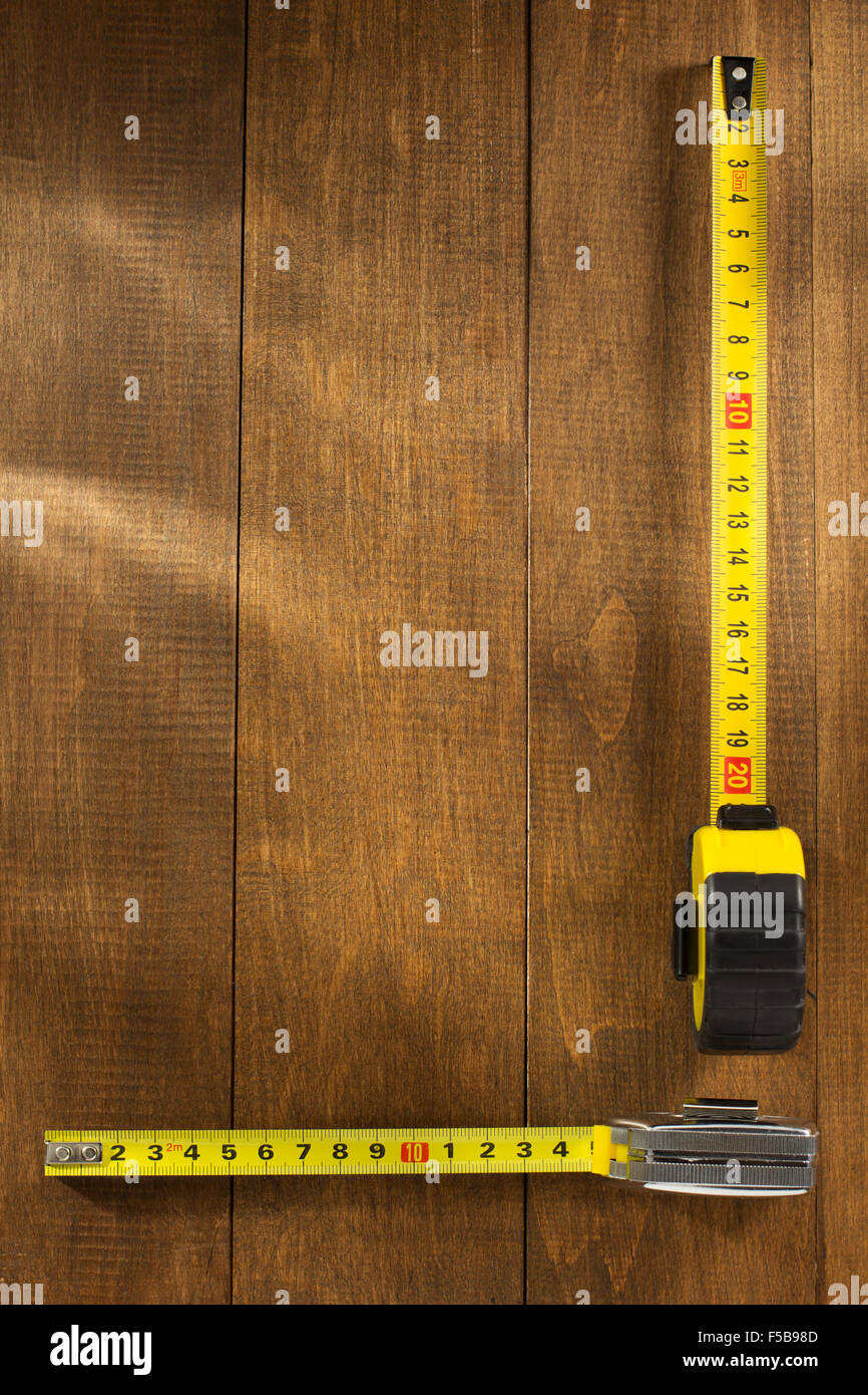 tape measure and pencil on wooden texture Stock Photo - Alamy
