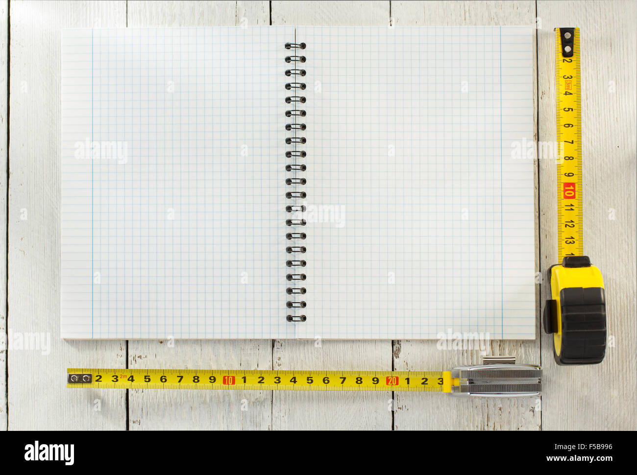 tape measure and notebook on wooden texture Stock Photo - Alamy