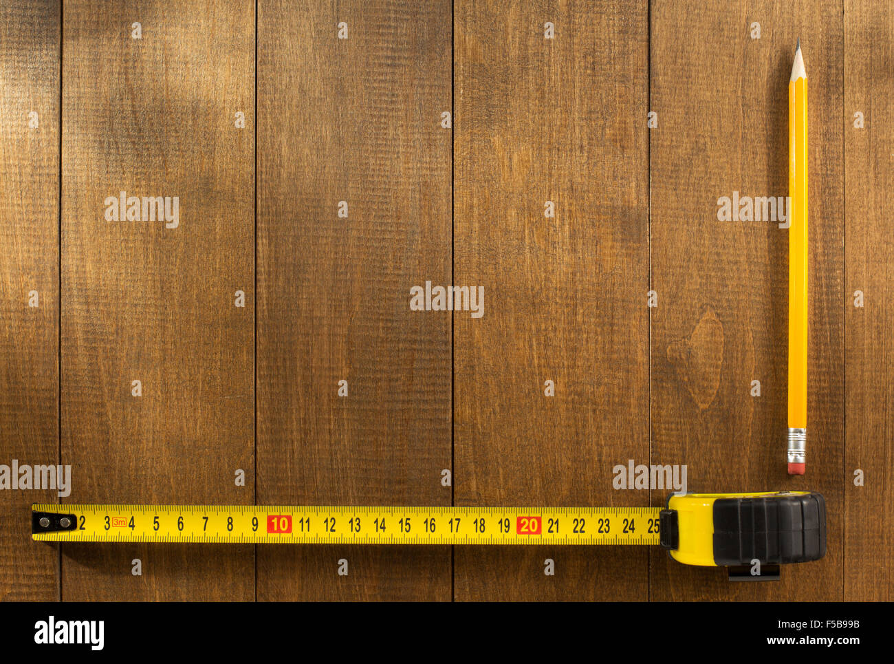 tape measure and pencil on wooden texture Stock Photo - Alamy